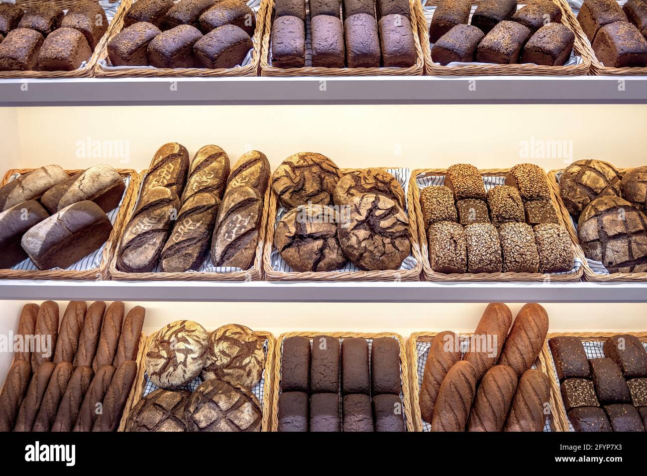 Freshly baked traditional dark bread in a baker shop. Different types ...