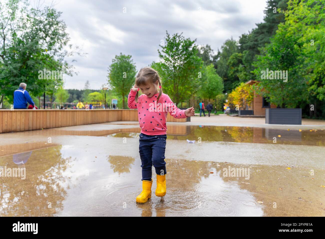 Children jumping in puddles hi-res stock photography and images - Alamy