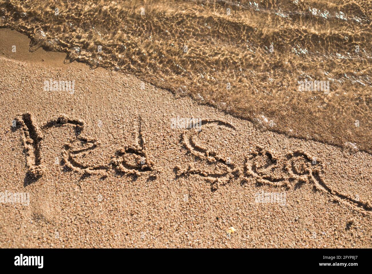 Word Red Sea written in the sand on the beach. Summer travel concept ...