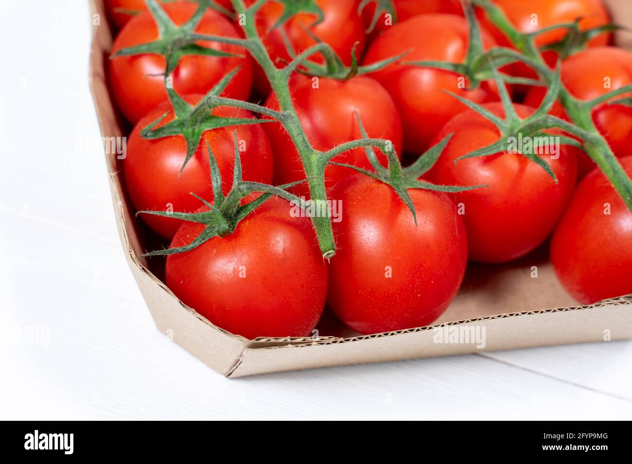 small red cherry tomatoes in a carton box close-up Stock Photo - Alamy