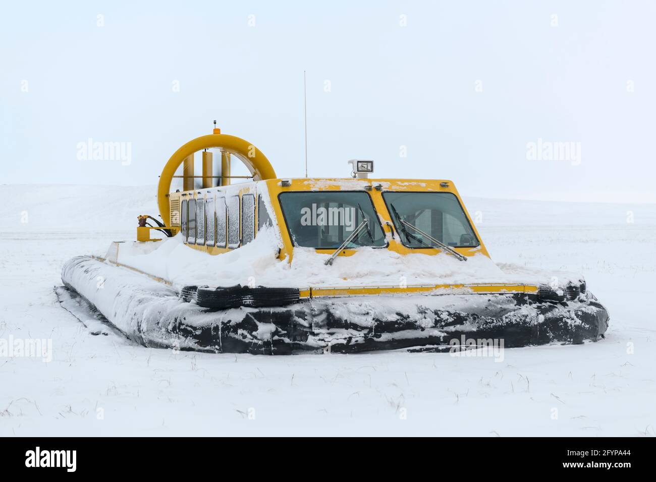 Hovercraft in winter tundra. Air cushion on the beach. Yellow hover ...