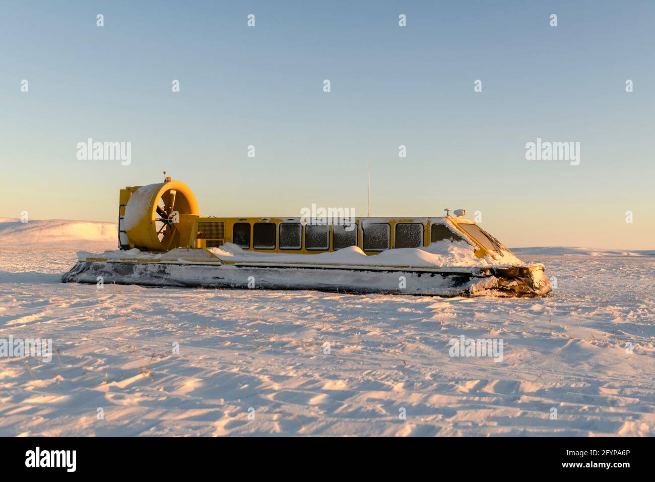Hovercraft in winter tundra. Air cushion on the beach. Yellow hover ...