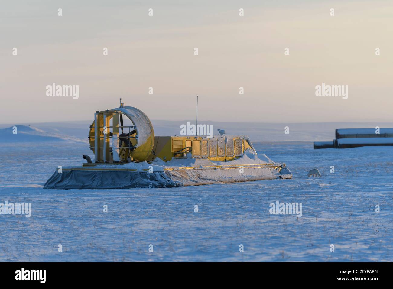 Hovercraft in winter tundra. Air cushion on the beach. Yellow hover ...