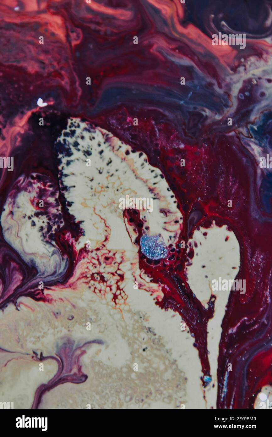 Vertical shot of an abstract oil painting with white and maro colors ...