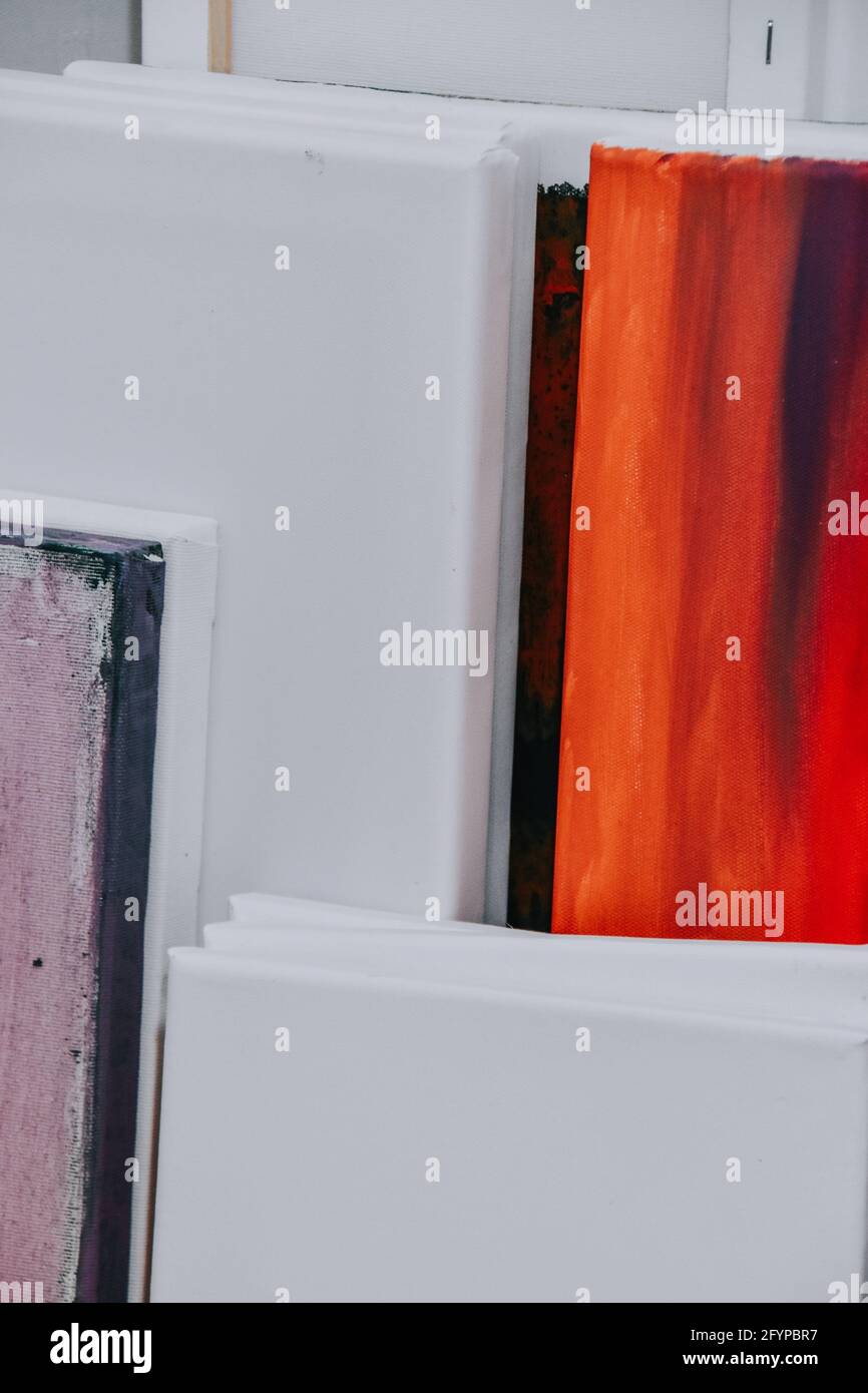 Vertical shot of abstract paintings and blank canvases at a stud Stock ...
