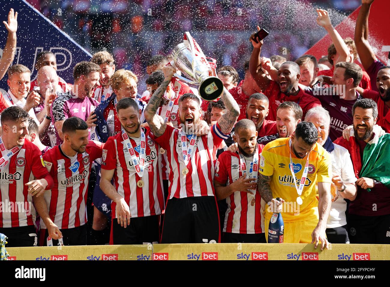 Brentford's Pontus Jansson lifts the trophy as they celebrate promotion ...
