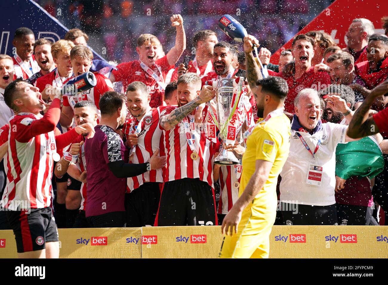 Brentford's Pontus Jansson lifts the trophy as they celebrate promotion ...