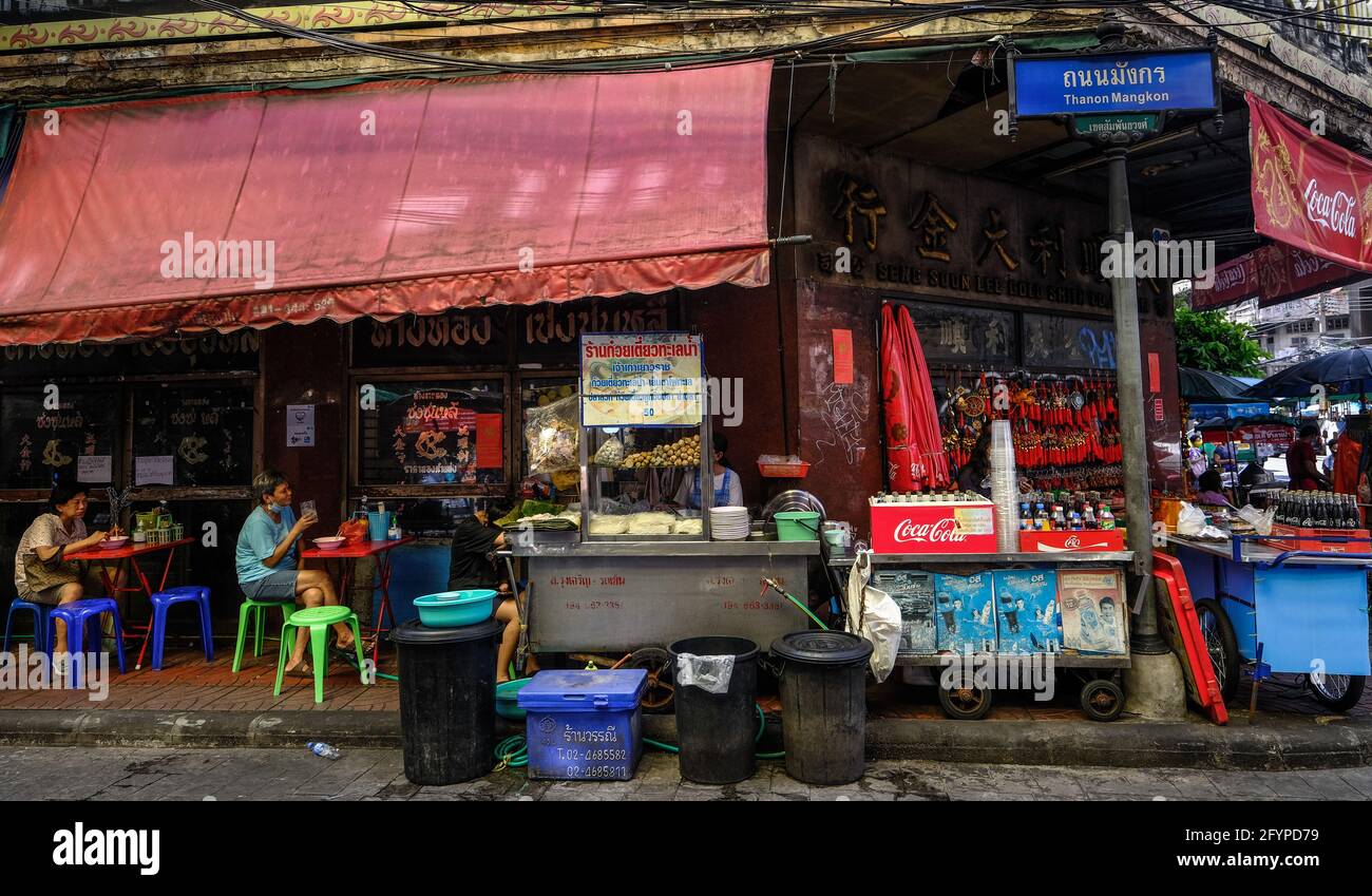 Women eat food at an outdoor restaurant in Chinatown, Bangkok, Thailand ...
