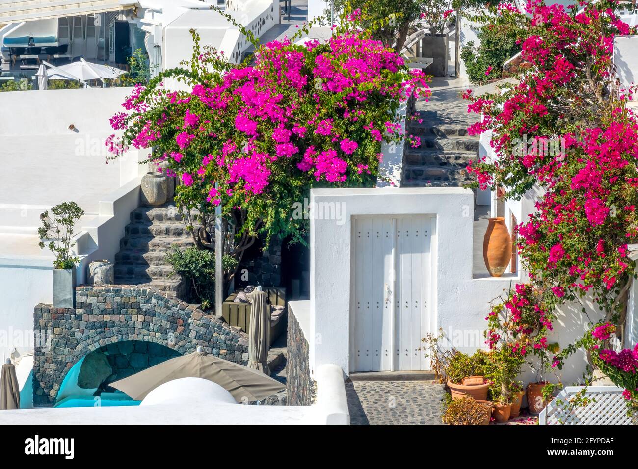 Greece. A sunny summer day on the island of Santorini. Small courtyards ...