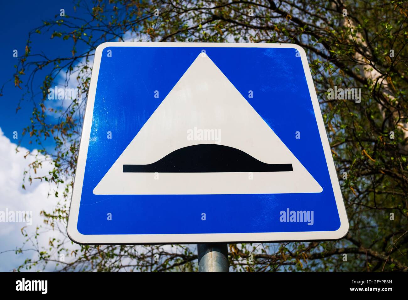 road sign speed bump. blue square with white triangle and black ...
