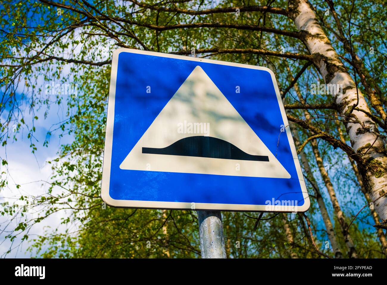 road sign speed bump. blue square with white triangle and black ...