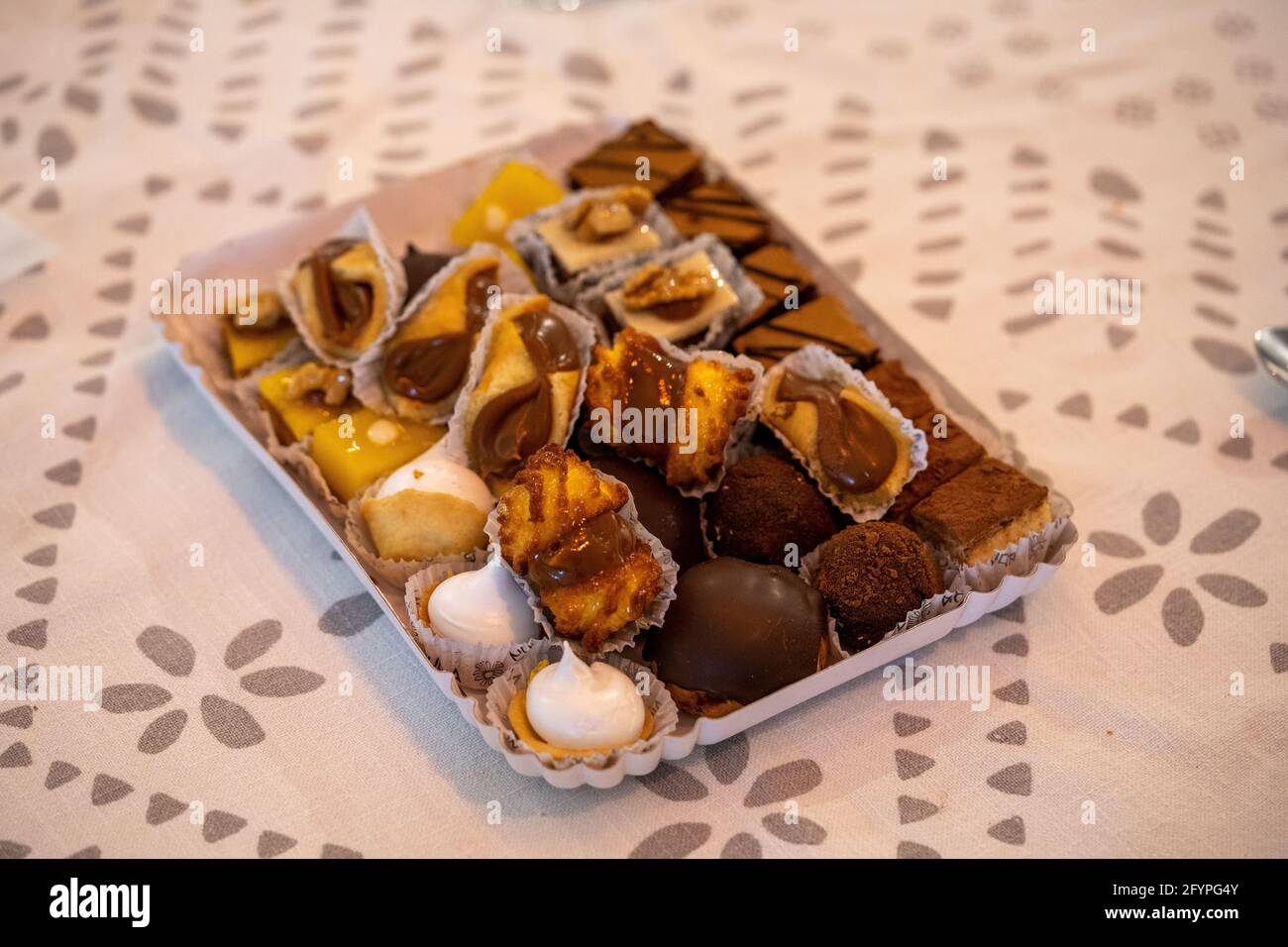 Selective focus shot of different type of sweets in a plastic plate ...