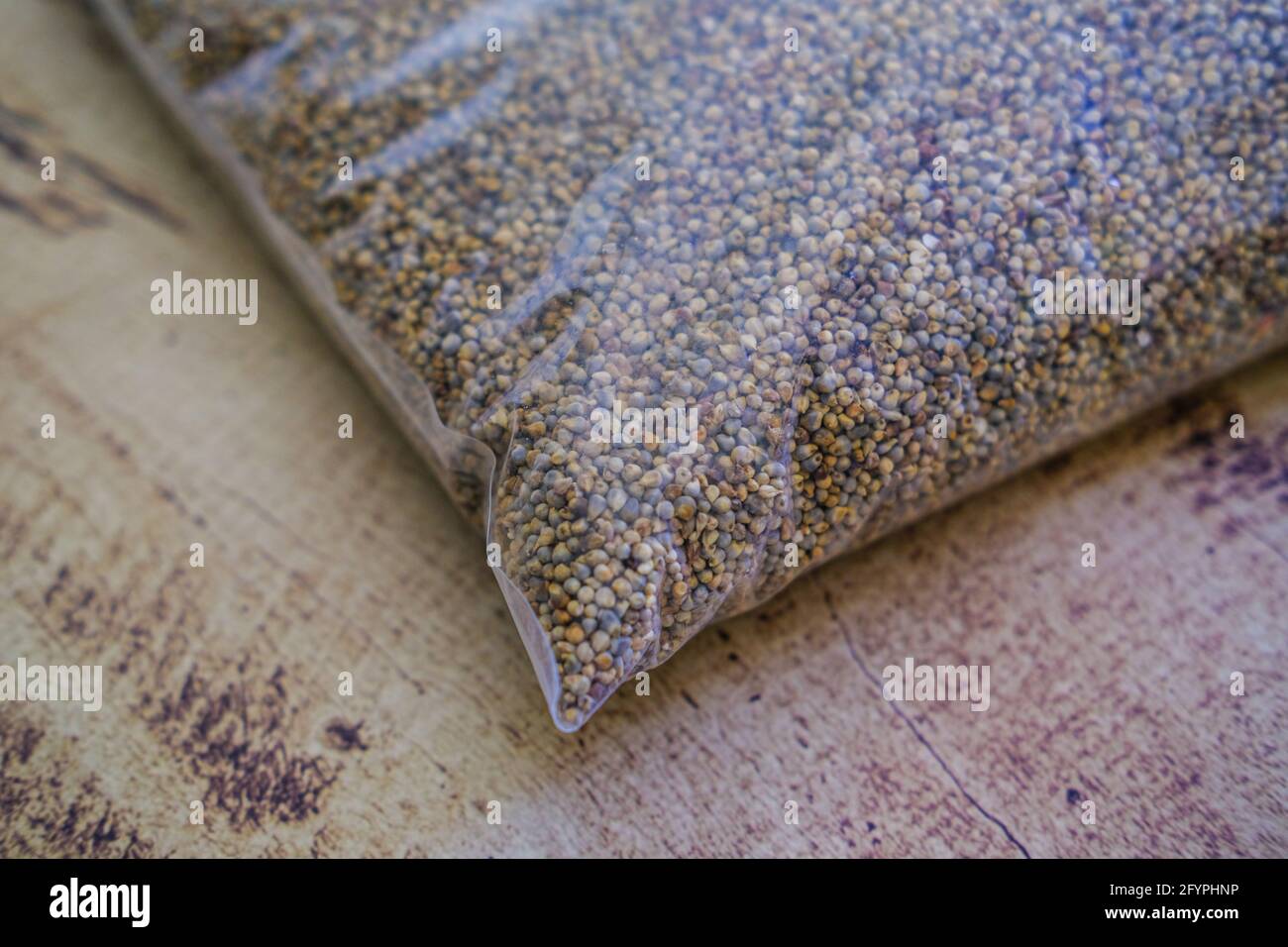 Bag of Nigerian millet on wood table Stock Photo - Alamy