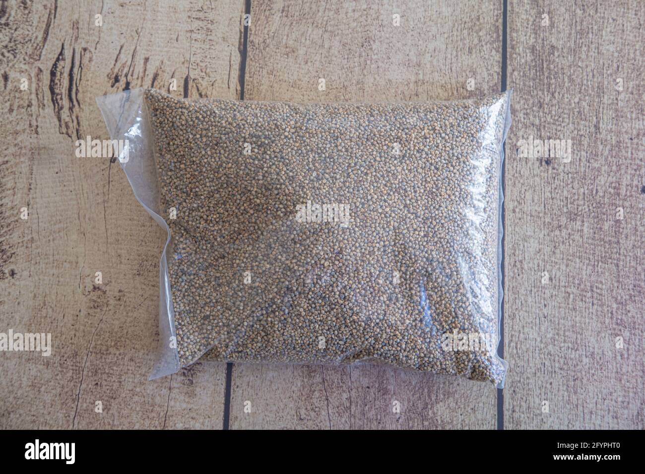 Bag of Nigerian millet on wood table Stock Photo - Alamy