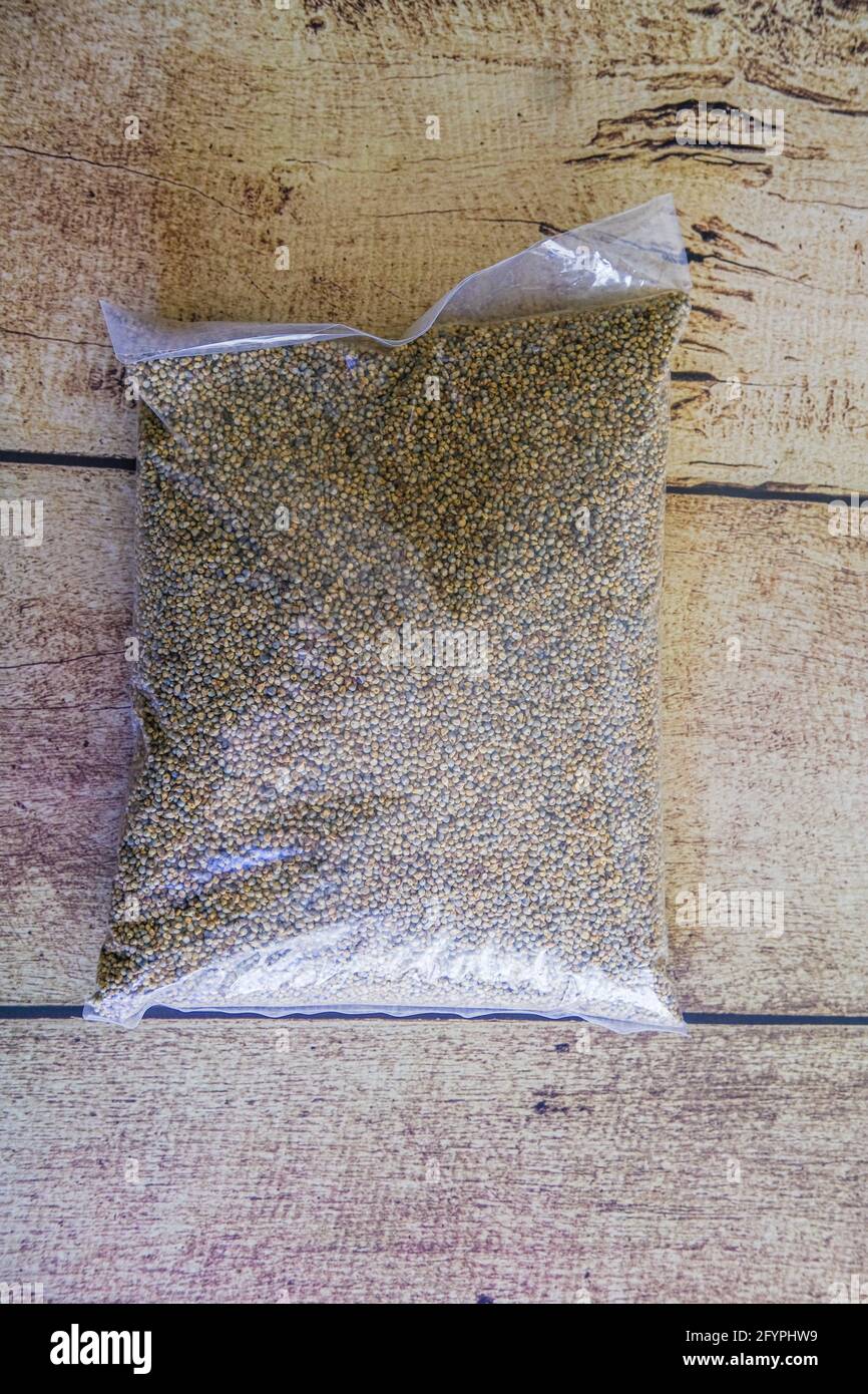 Bag of Nigerian millet on wood table Stock Photo - Alamy