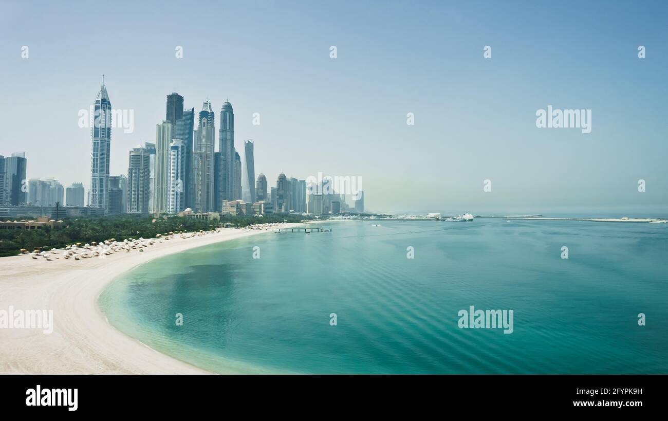 Dubai city skyline with skyscrapers, sea and beach. Travel, tourism ...