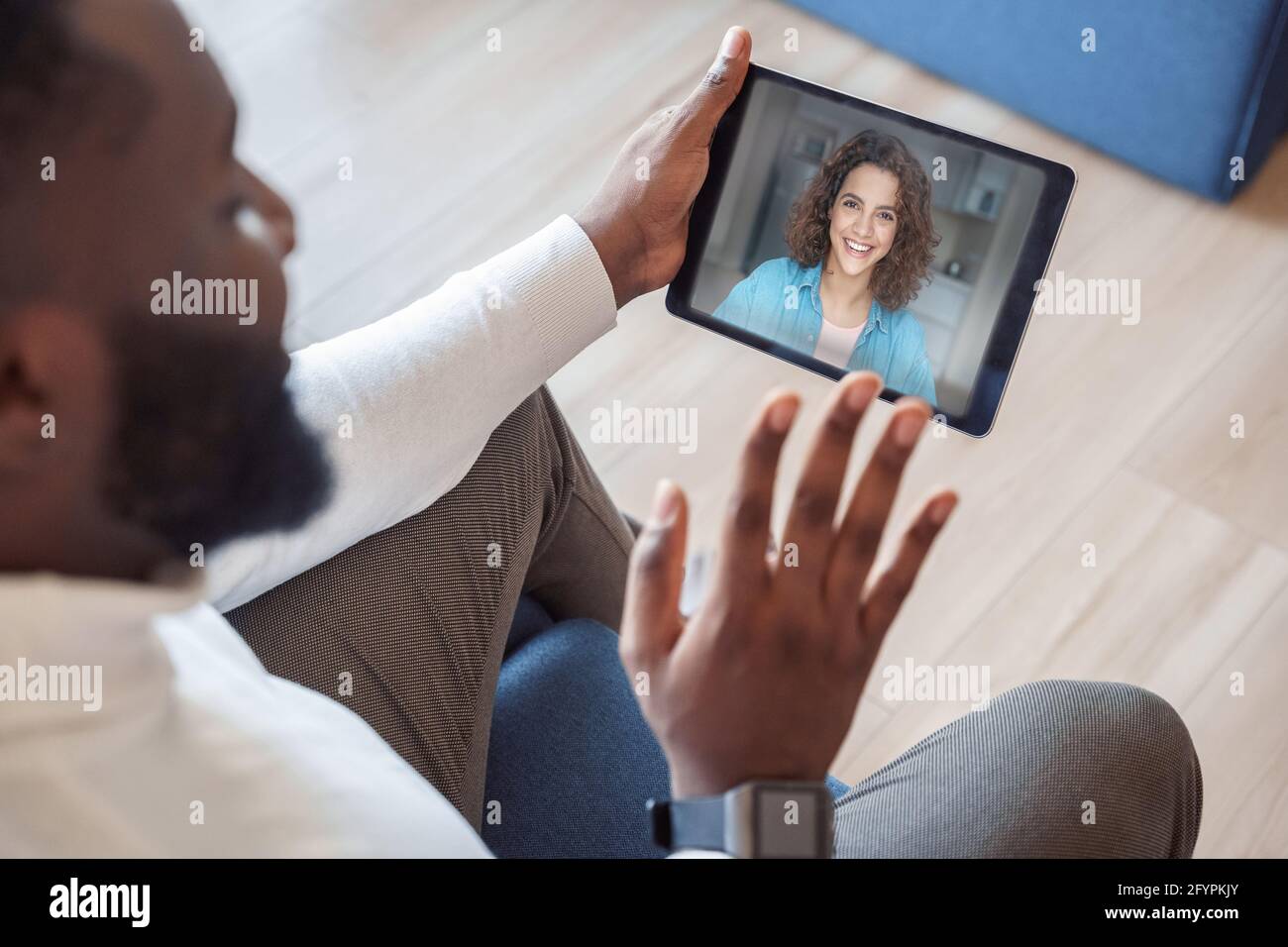 Back view of african american man making video call with woman stay at ...