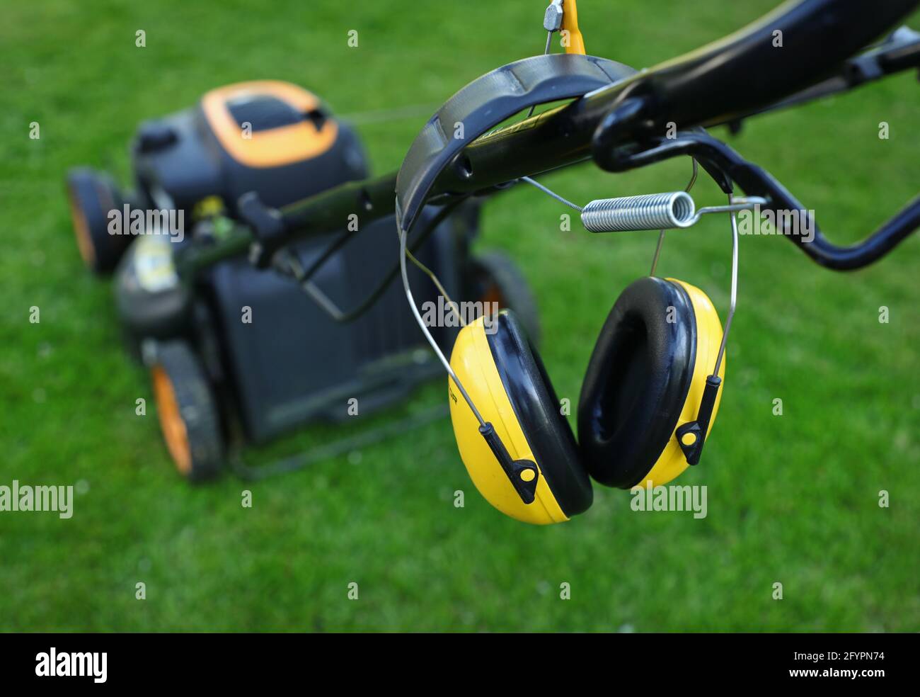 Peltor hearing protection on a lawn mower Stock Photo - Alamy