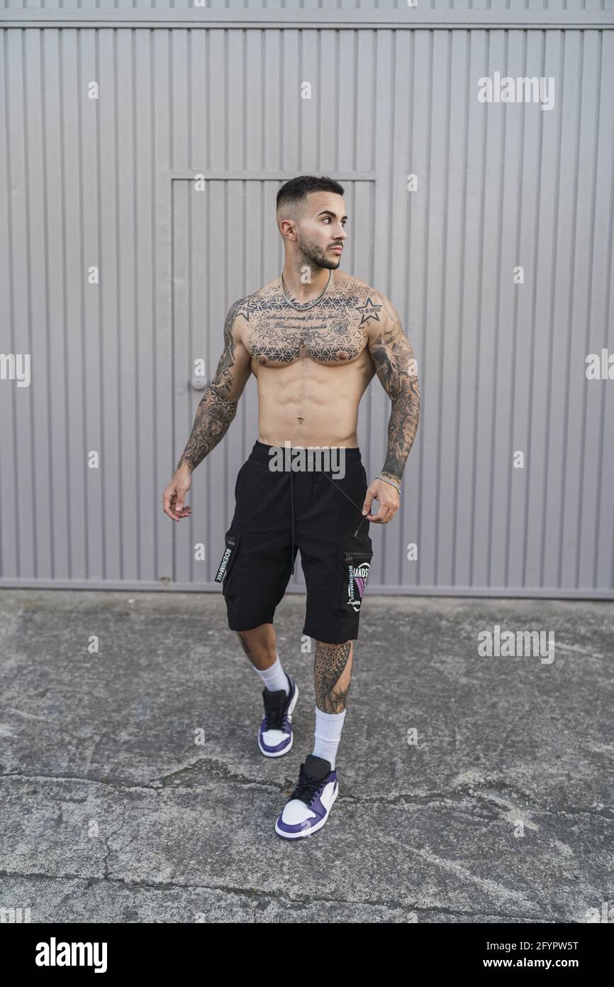 Young Spanish man with tattoos and casual style Stock Photo - Alamy
