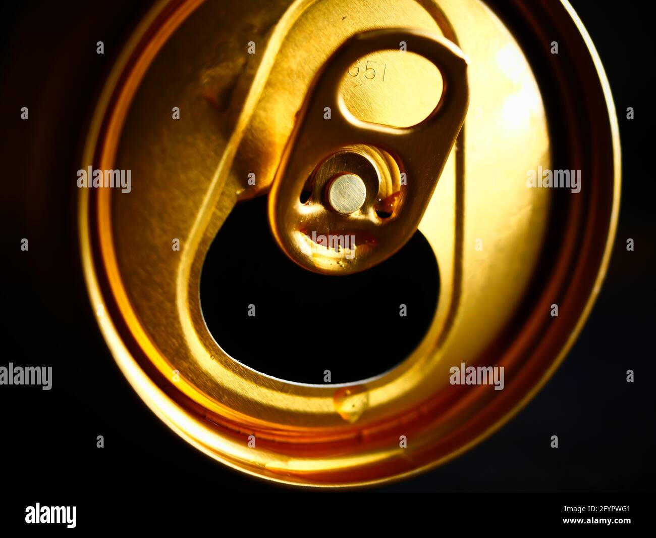 Closeup shot of a golden empty open drink can in the dark Stock Photo ...