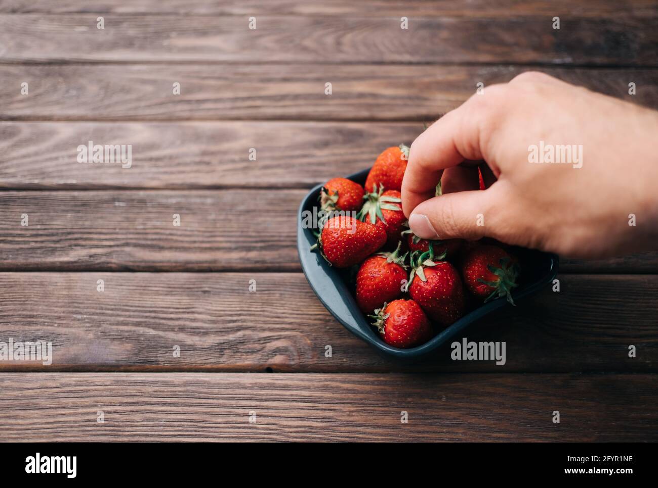 Man takes one berry hi-res stock photography and images - Alamy