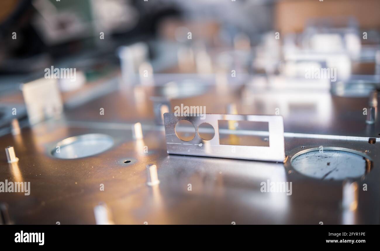 Metal boards and accessories lie on the surface during the production ...