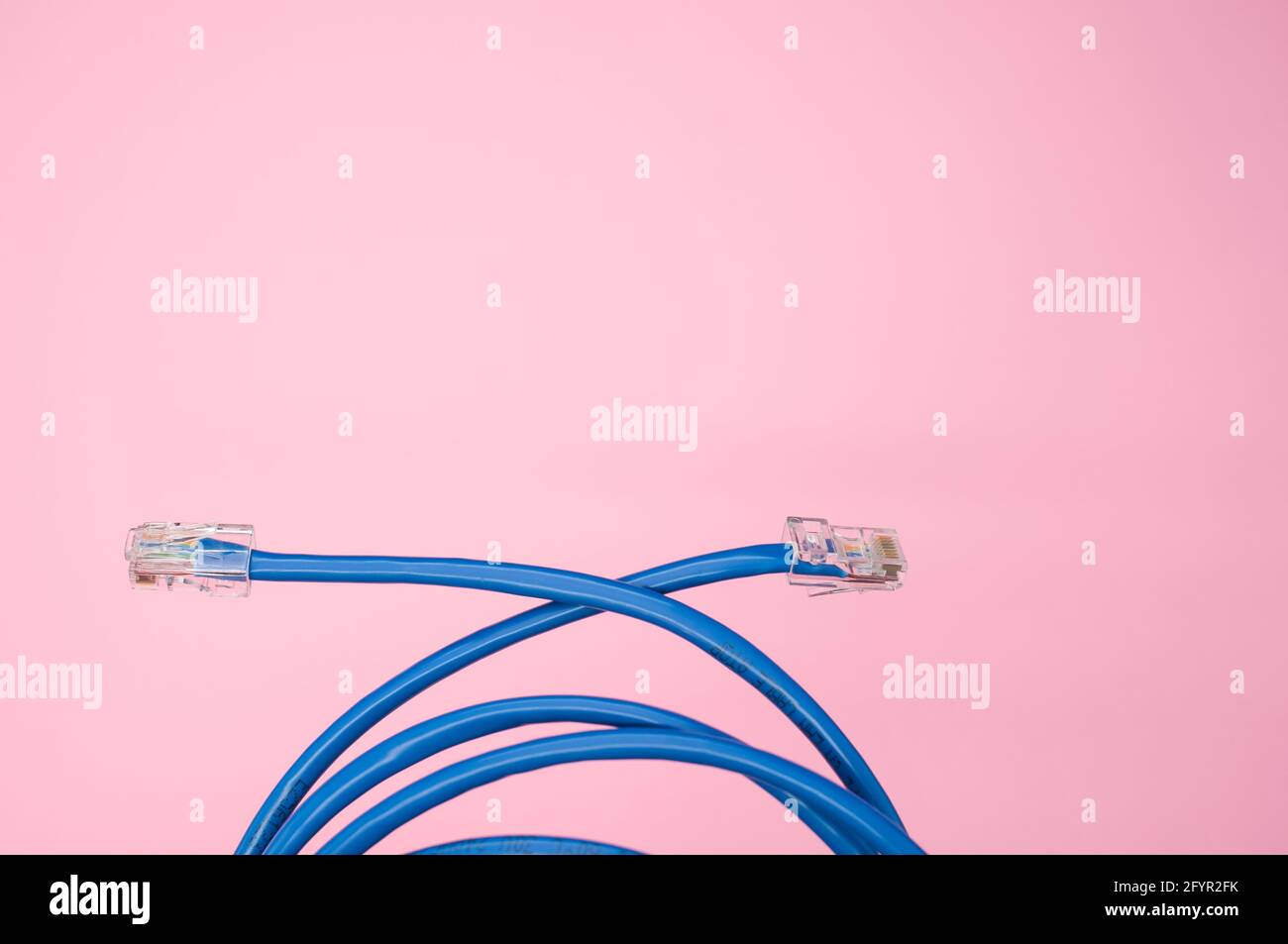 A top view of a blue LAN cable isolated on a pink background Stock ...