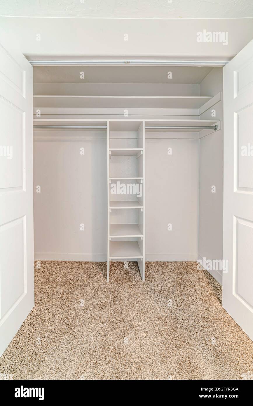 Minimalistic closet interior design in white color with empty racks ...