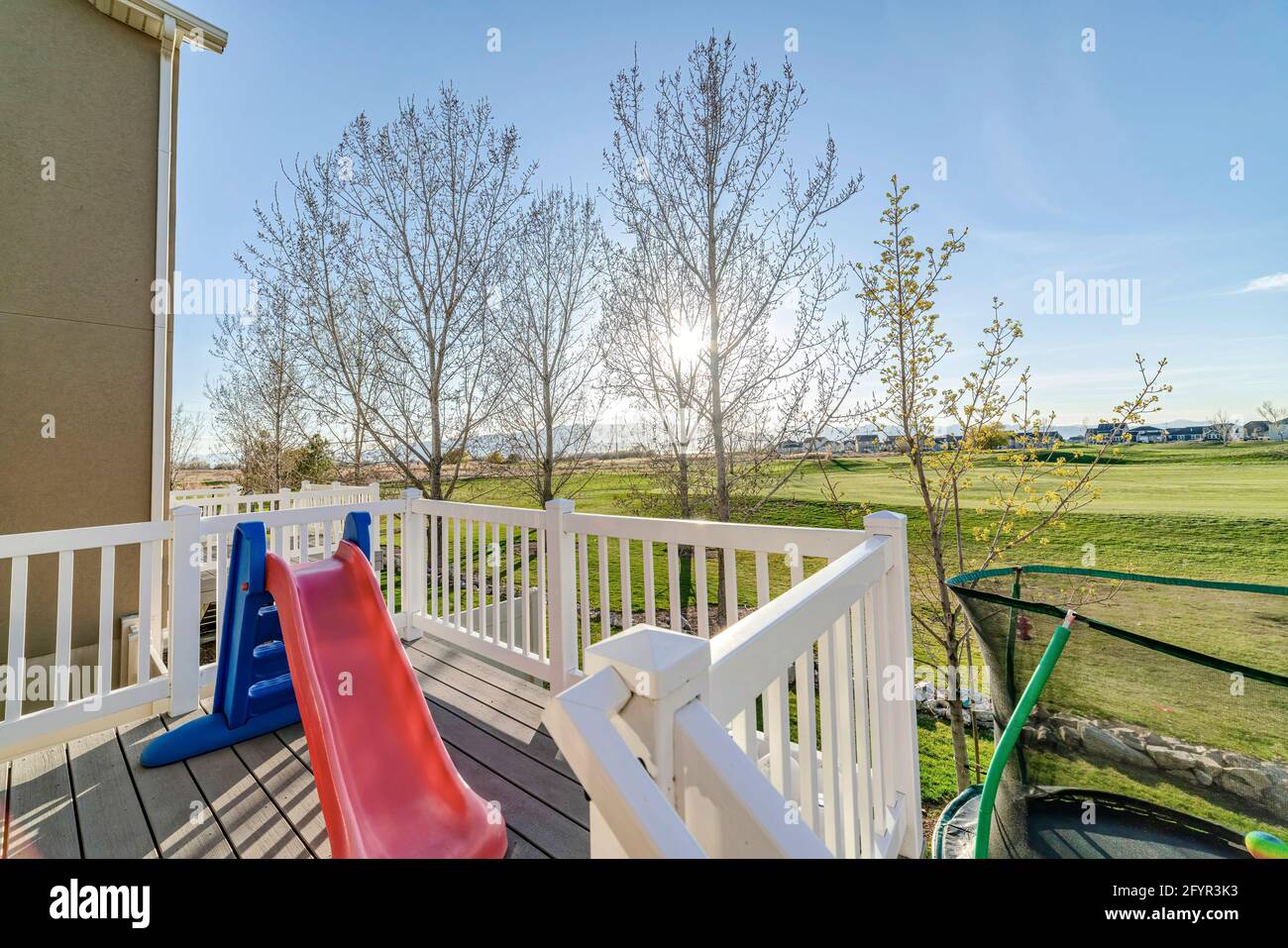 Beautiful sunny terrace with kids swing on background of deciduous ...