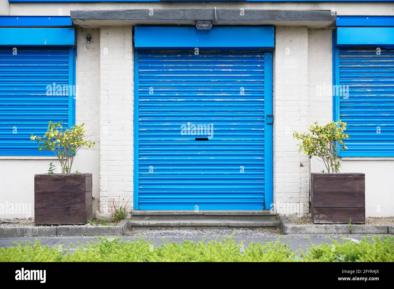 Shop front with blank sign and closed shutter door Stock Photo - Alamy