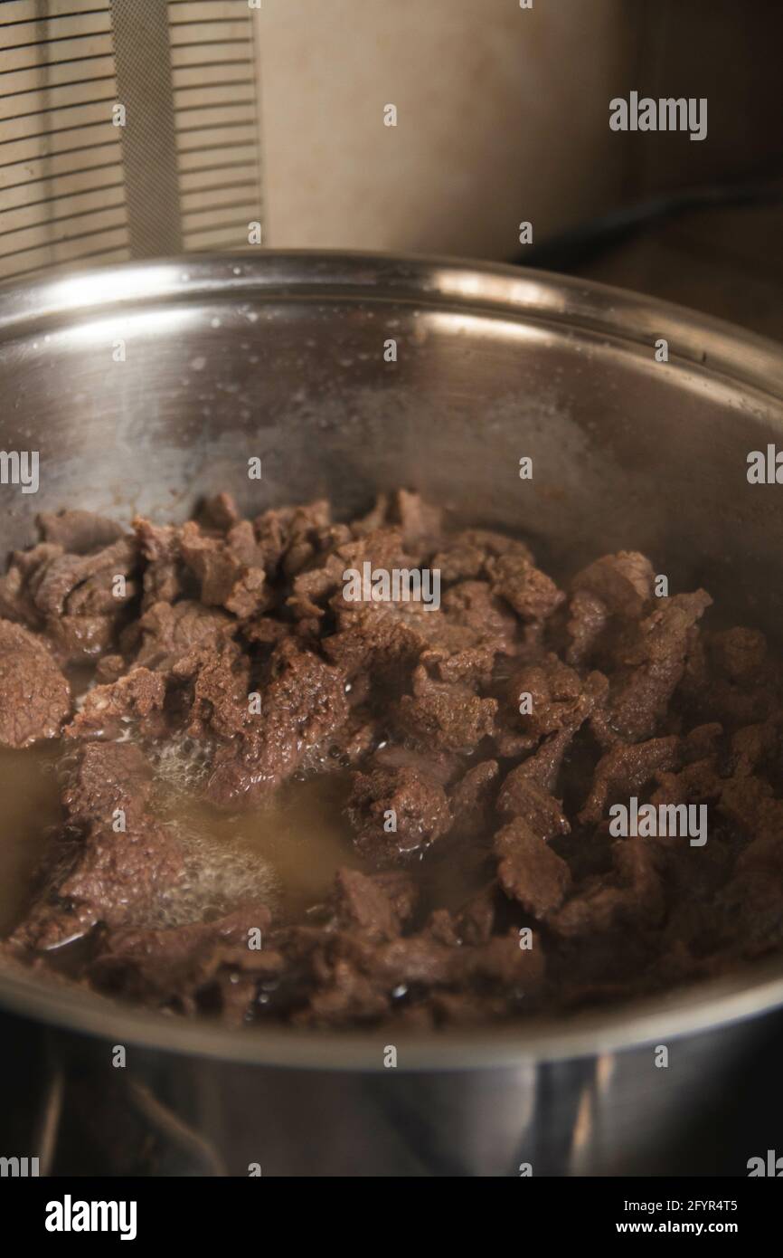 Vertical shot of appetizing sliced beef boiling in the pot Stock Photo ...