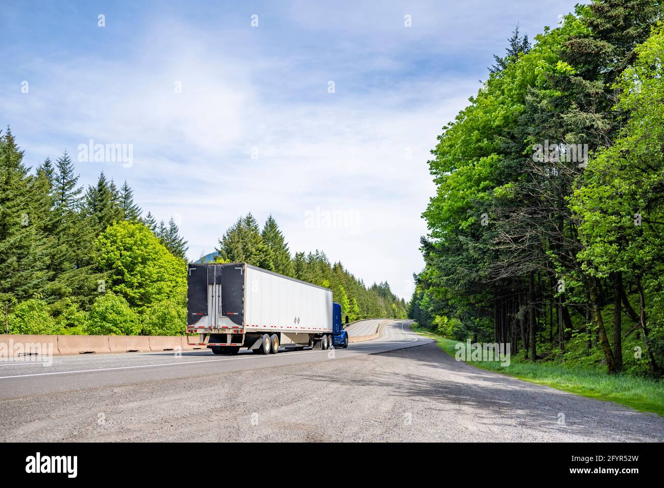 Blue big rig industrial semi truck tractor with roof spoiler ...