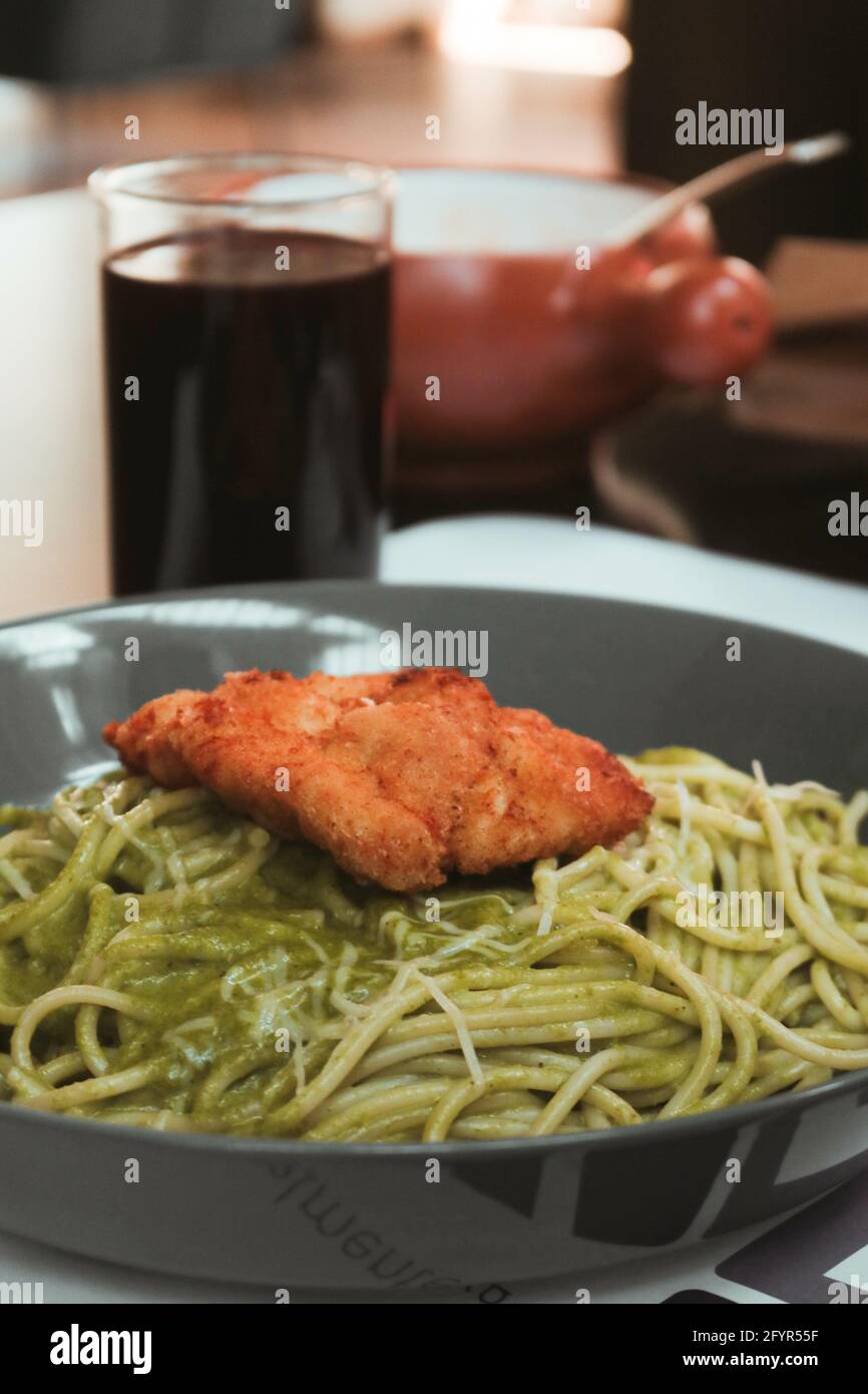 Vertical shot of appetizing pesto pasta with parmesan cheese and ...