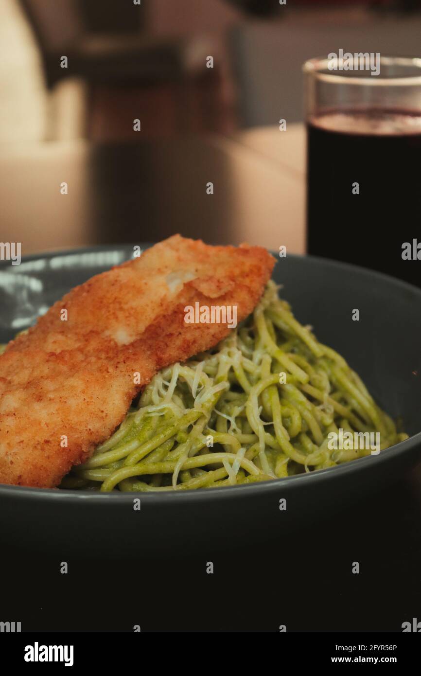 Vertical shot of appetizing pesto pasta with parmesan cheese and ...