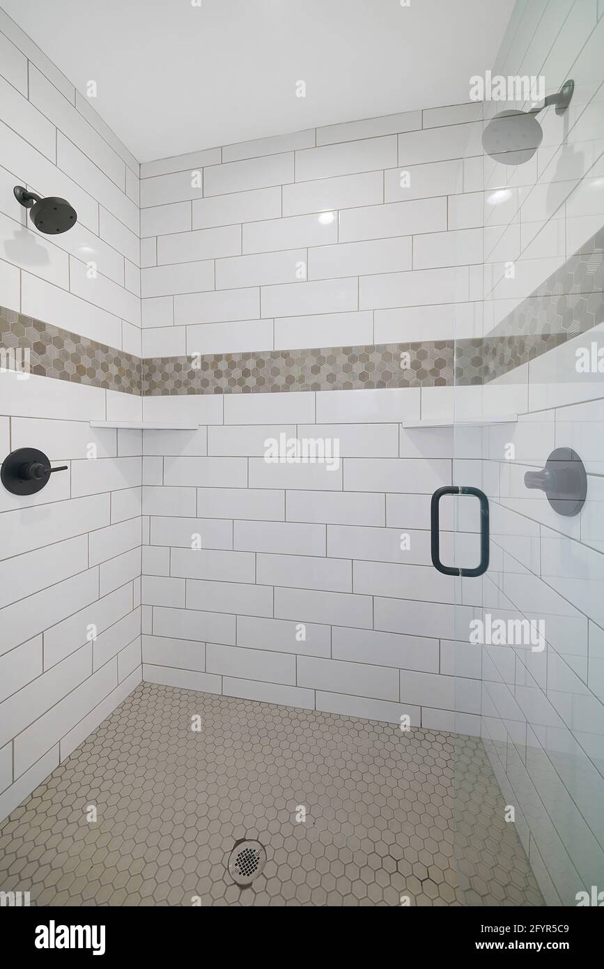 Minimalistic bathroom interior design in white and brown tiles with a shower cabin Stock Photo ...