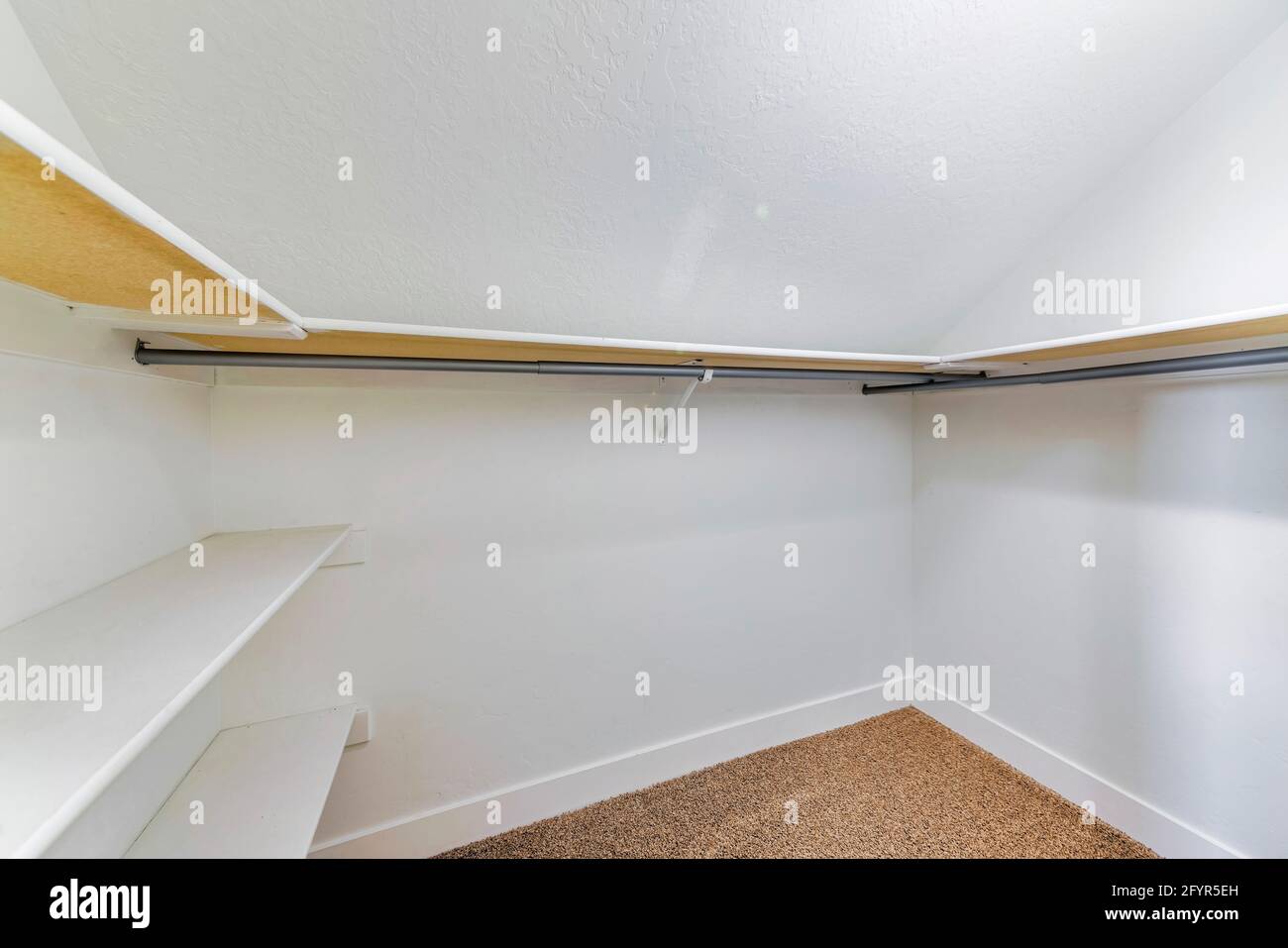 Minimalistic closet interior design in white color with empty racks ...