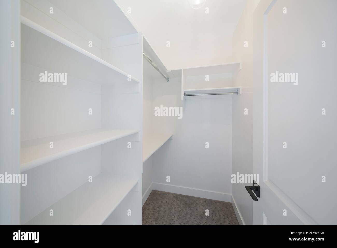 Minimalistic closet interior design in white color with empty racks ...