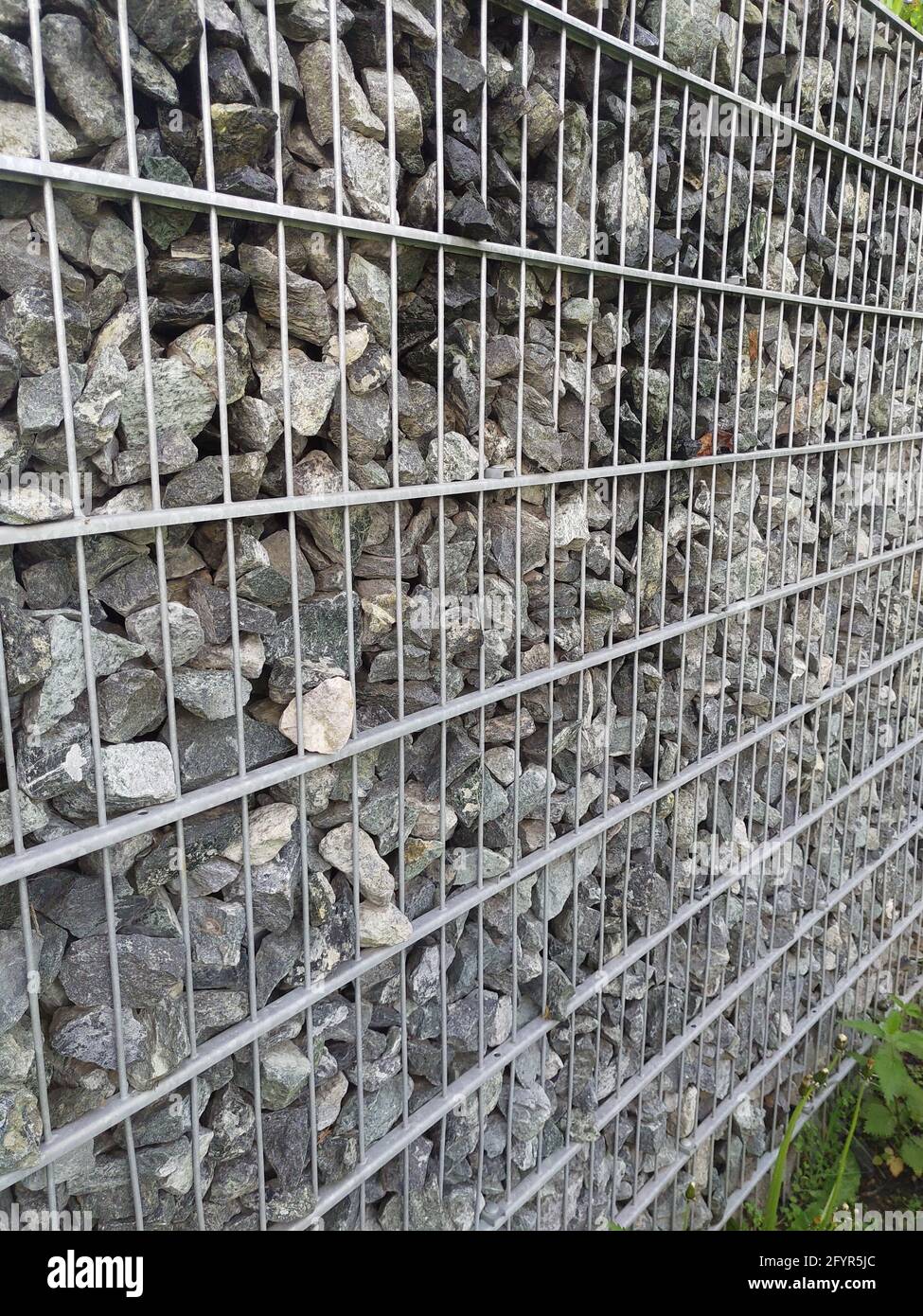 Gabion wall filled with stones Stock Photo - Alamy