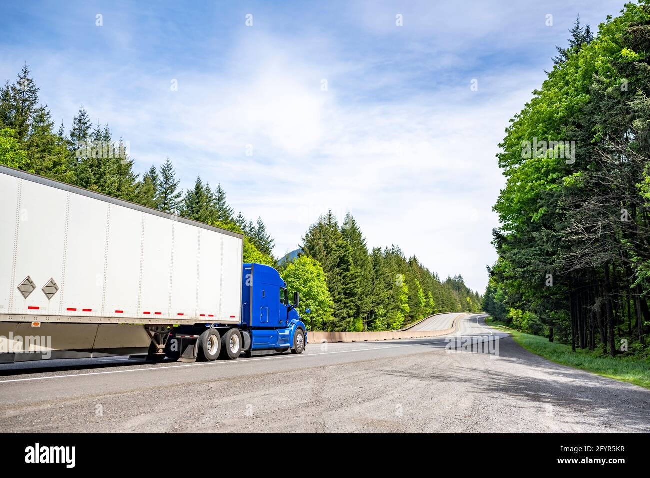 Blue big rig long haul industrial semi truck tractor with roof spoiler ...