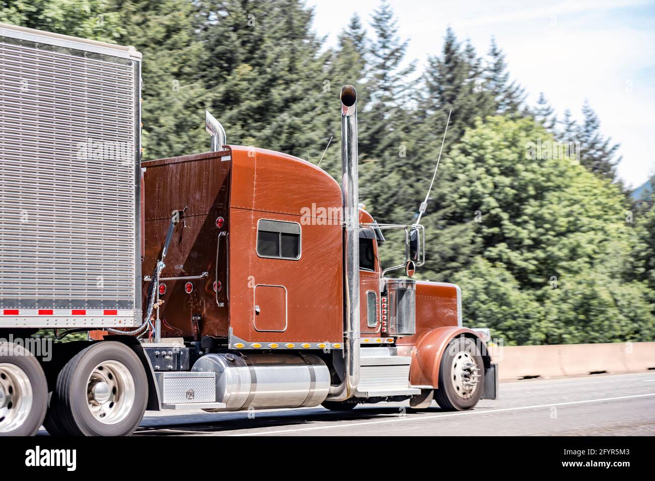 Brown big rig semi truck tractor with vertical chrome pipes ...