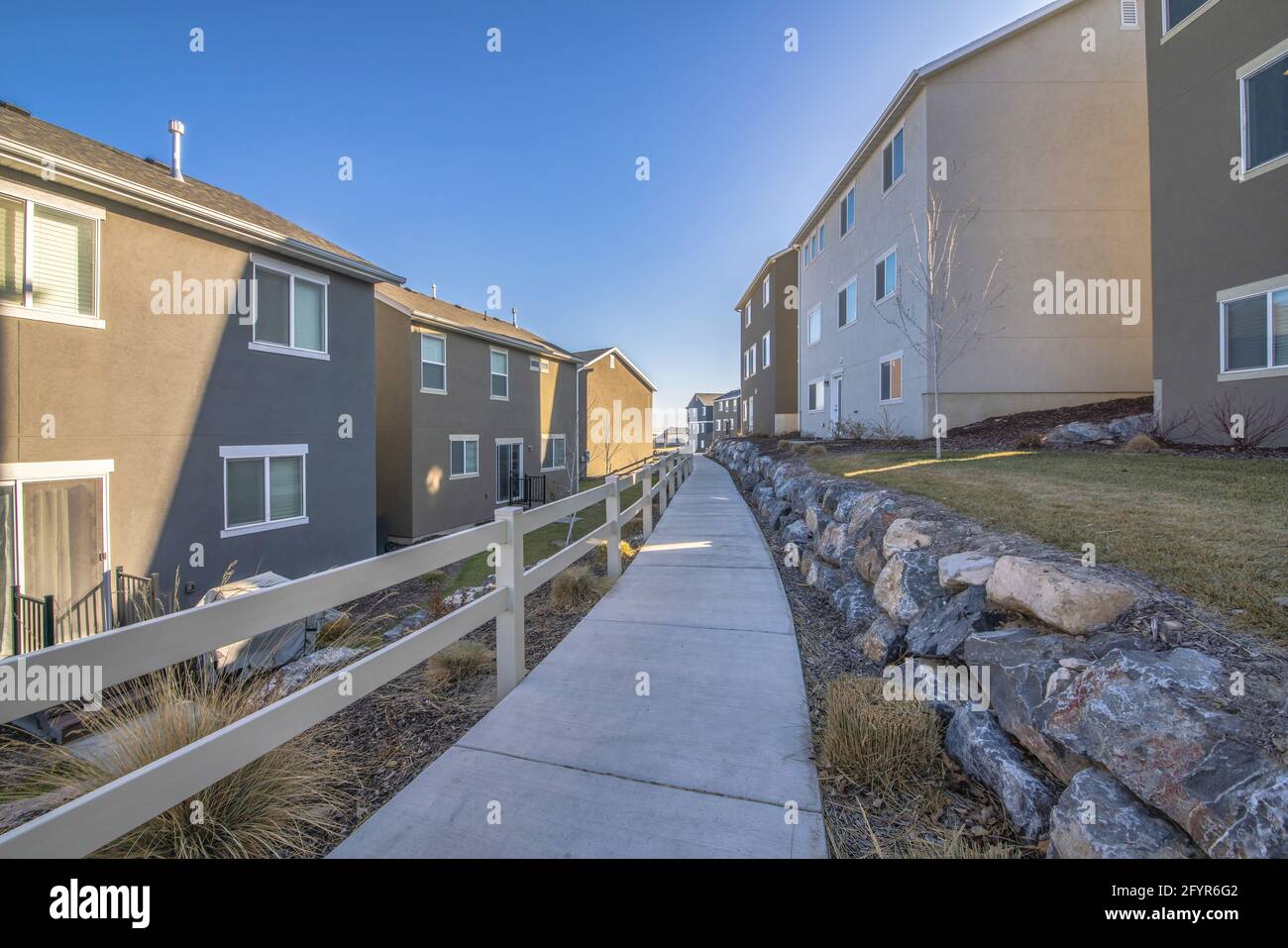Stone footpath with residential buildings on both sides Stock Photo - Alamy