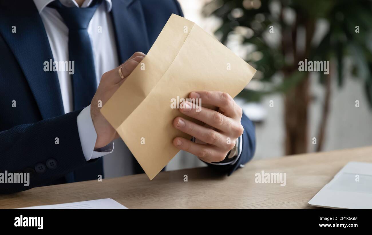 Hands of businessman opening paper envelope, taking out letter Stock ...
