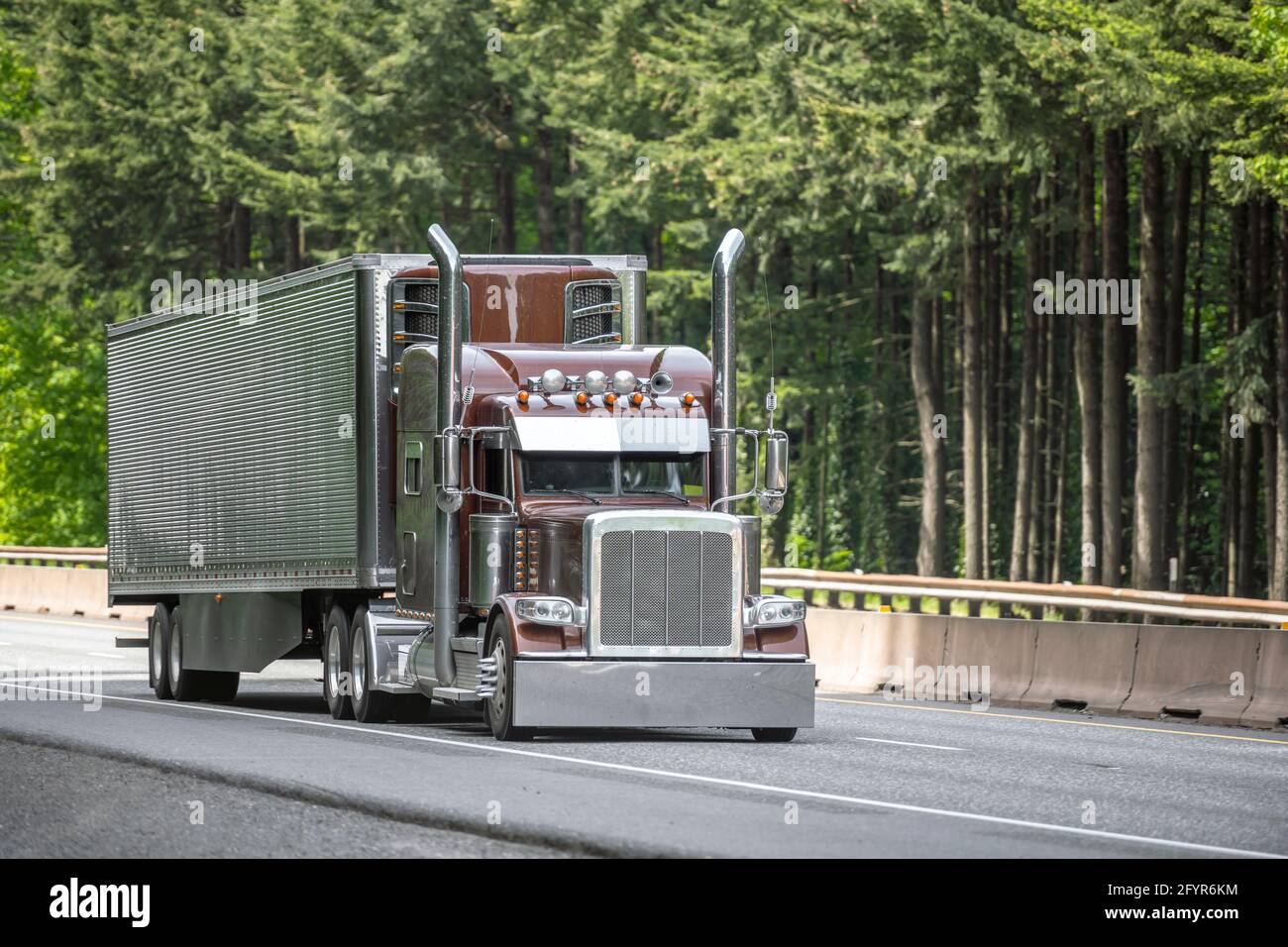 Brown big rig semi truck tractor with vertical chrome pipes ...