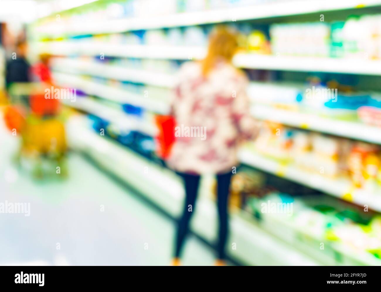 Woman near supermarket racks hi-res stock photography and images - Alamy