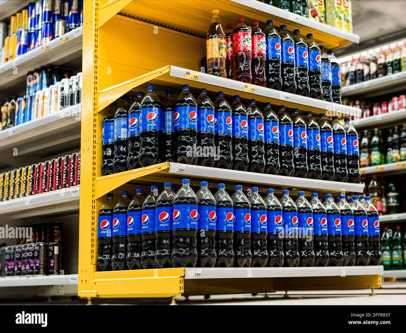 Pepsi Cola in plastic bottles stacked on supermarket rack Stock Photo ...