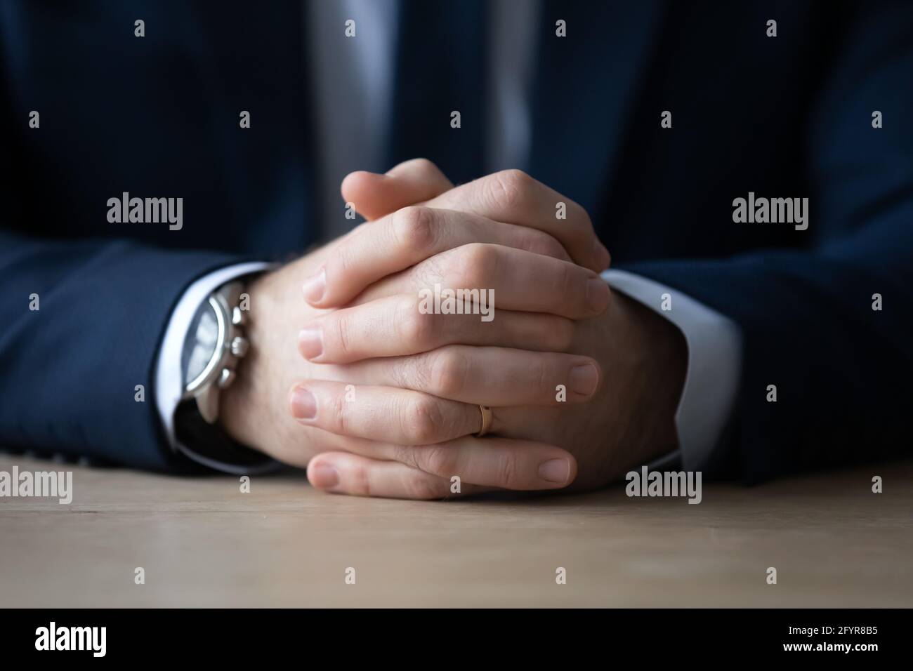 Sitting on hands suit hi-res stock photography and images - Alamy