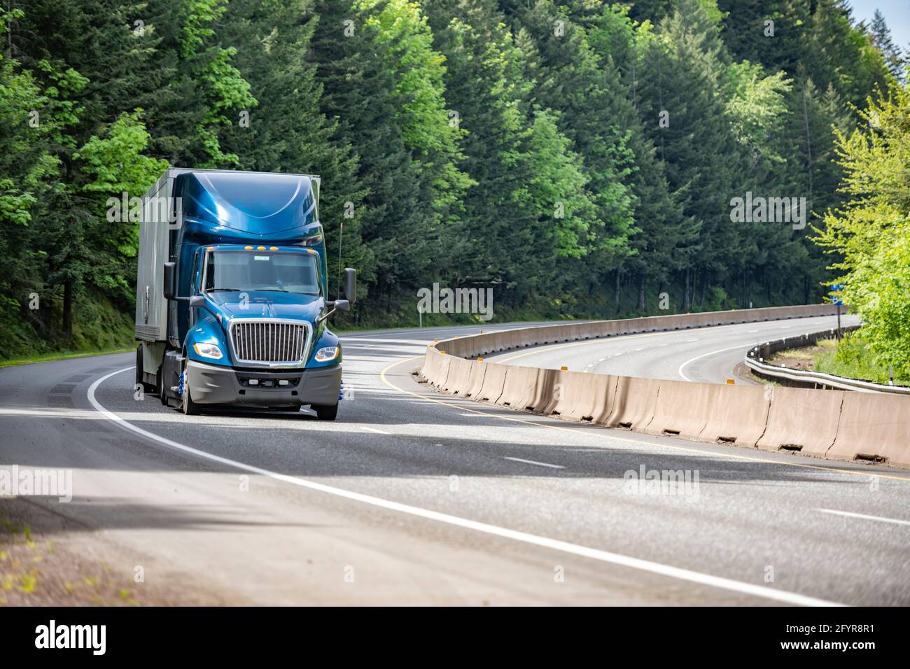 Dark blue big rig long haul industrial semi truck tractor transporting ...