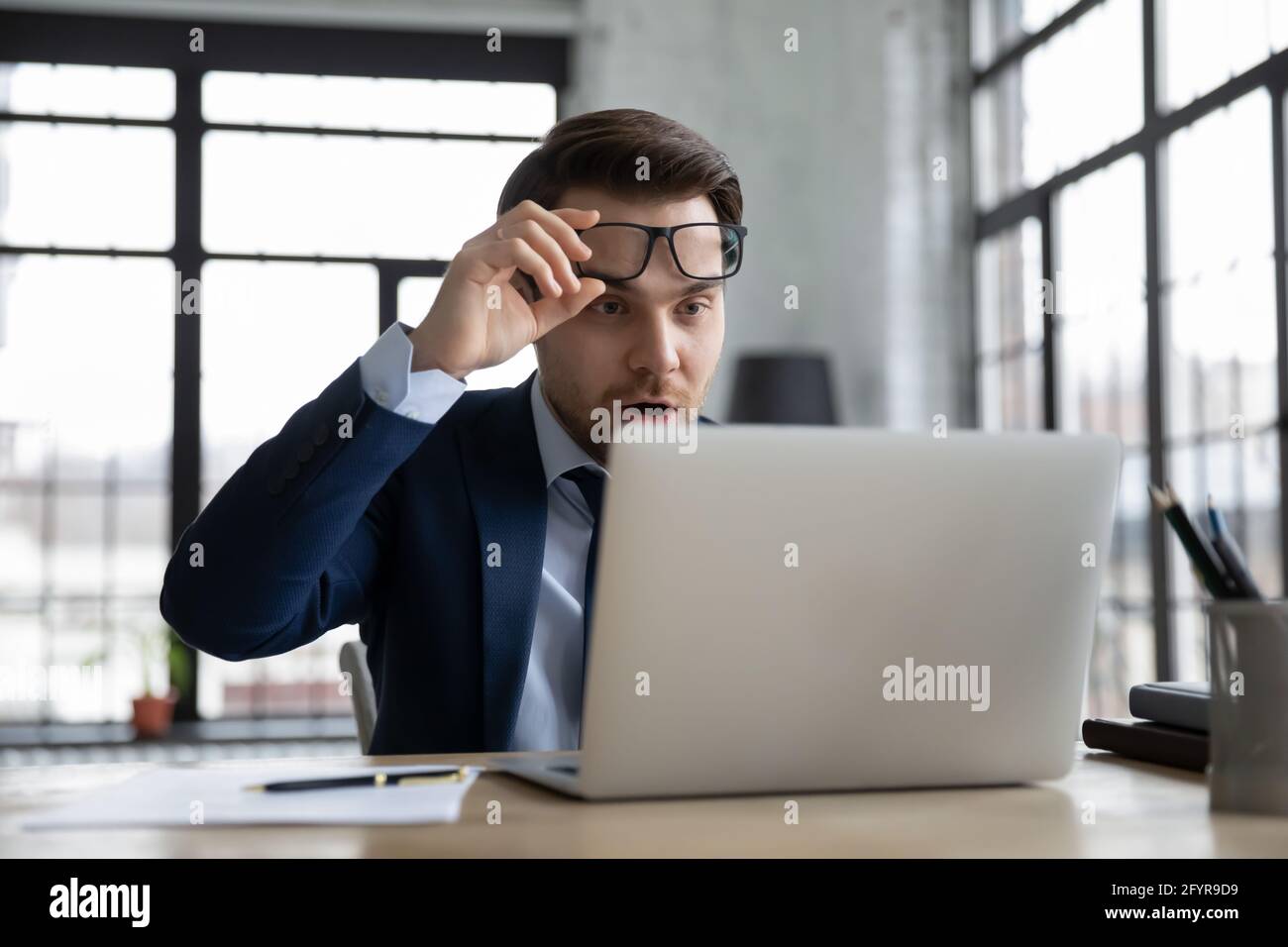 Overjoyed shocked businessman reading message with surprising good news ...