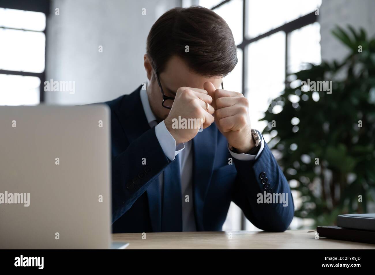 Tired overworked business professional going through stress at ...