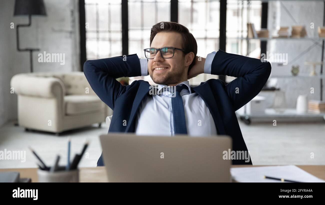 Happy manager relaxing at workplace in office, enjoying work break ...